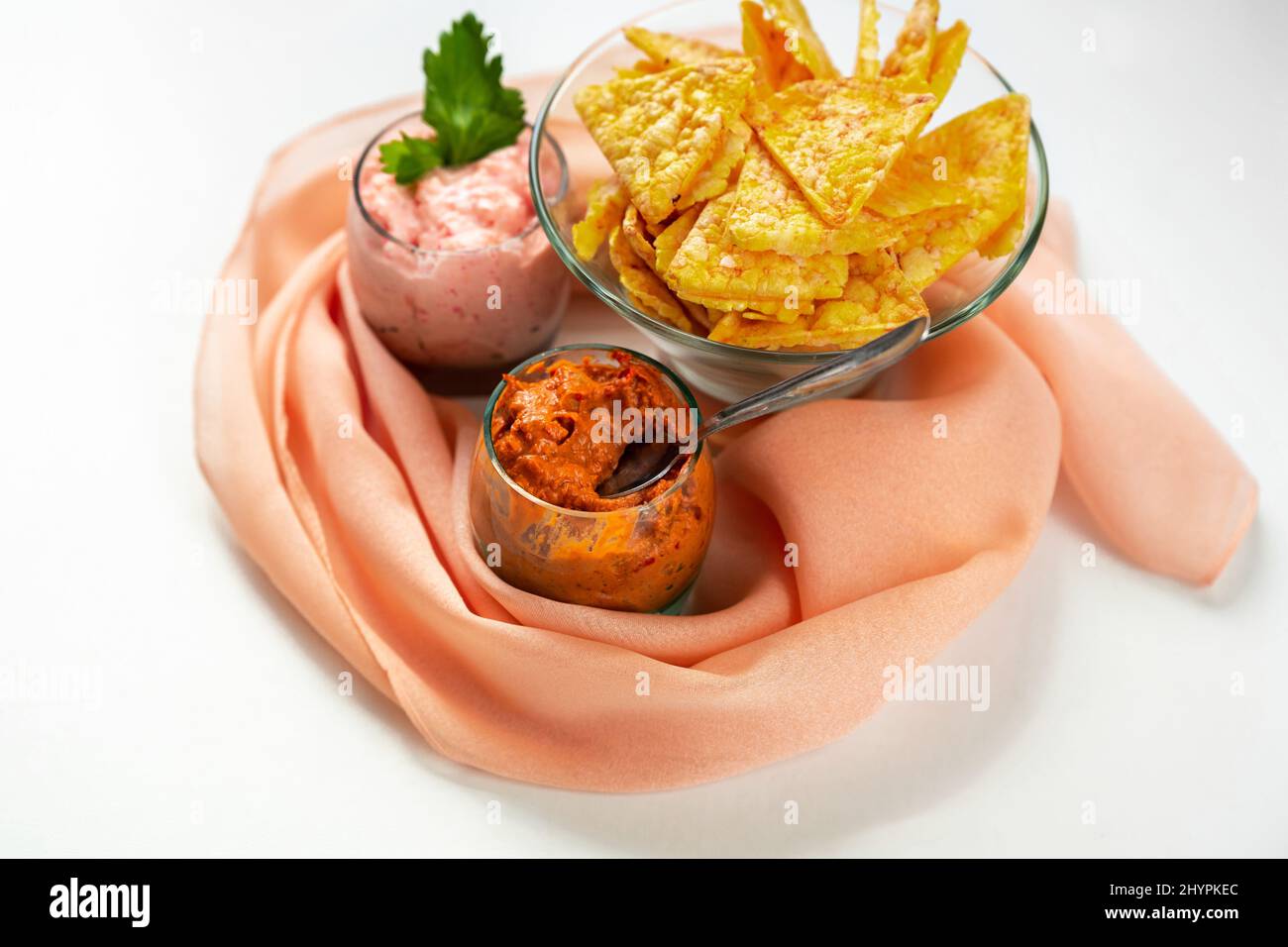 Two spread (tomato and red pepper, salmon) in small glasses, maize ...