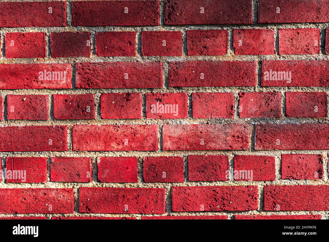 Reddish stone wall as a background Stock Photo - Alamy