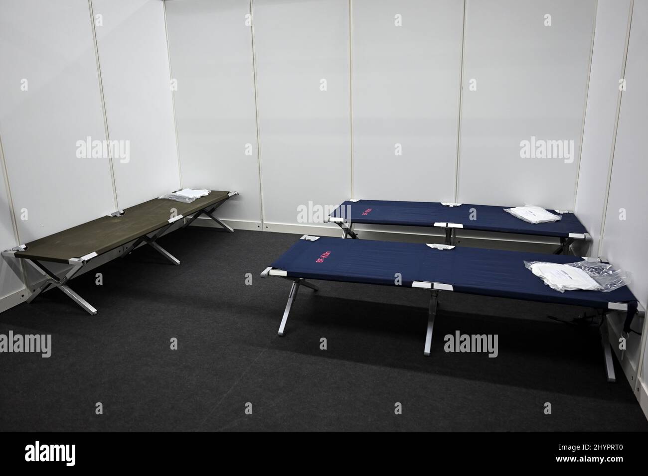 Cologne, Germany. 15th Mar, 2022. Three cots stand in a sleeping cell ...