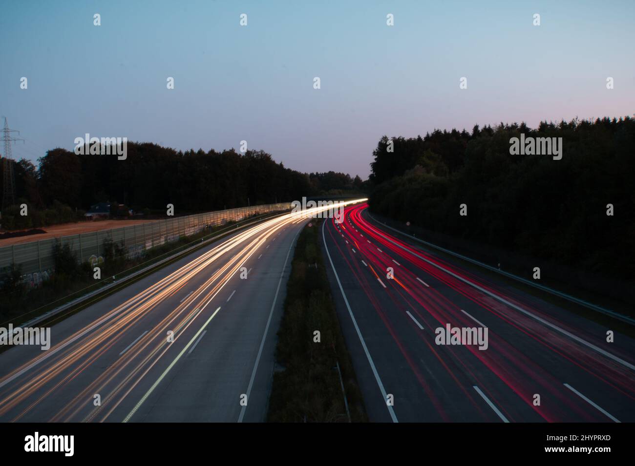 Scenic long exposure photography of a traffic amid forests Stock Photo ...