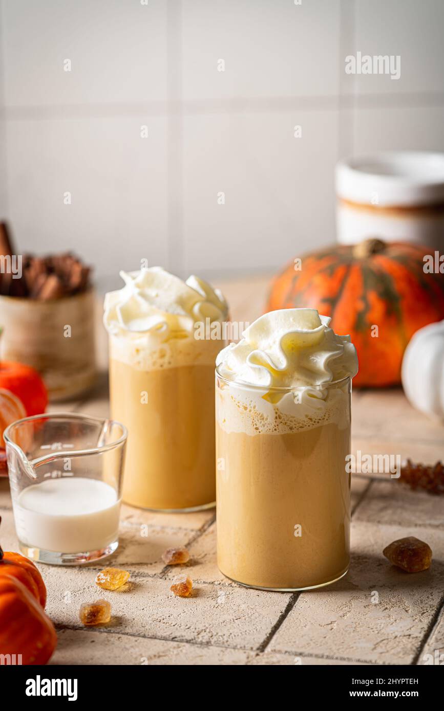 Autumn pumpkin spice latte with whipped cream and cinnamon on light ...