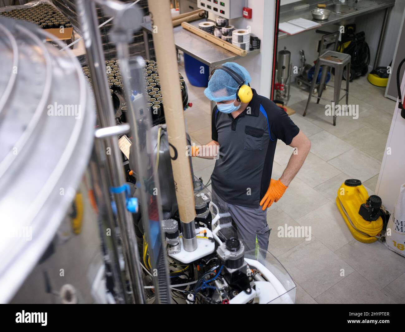 Operator of a craft beer brewery working with a machine Stock Photo - Alamy