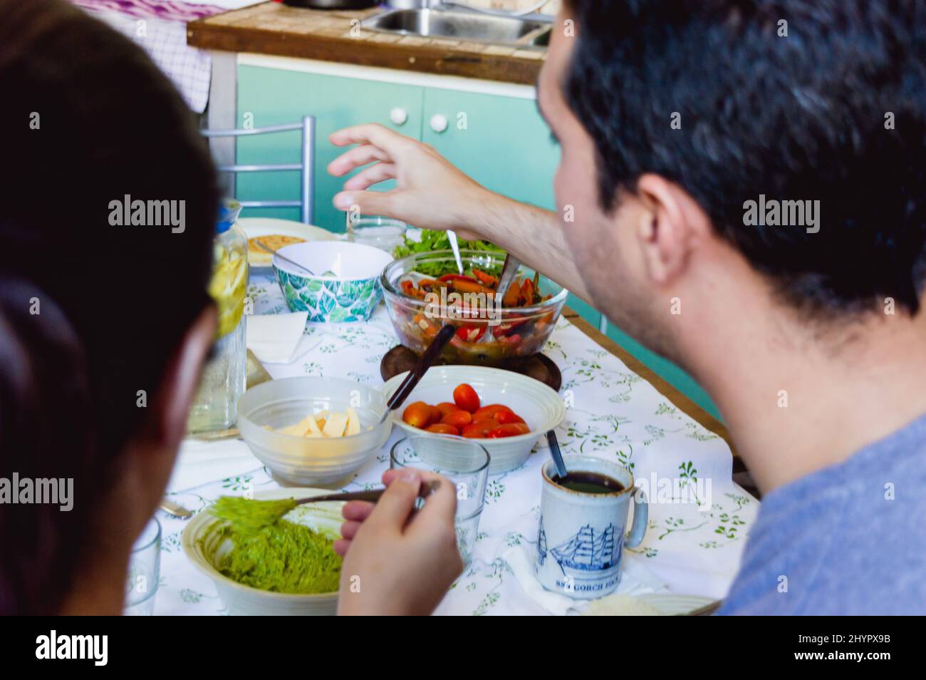 back view and close up of caucasian couple enjoying eating lunch ...