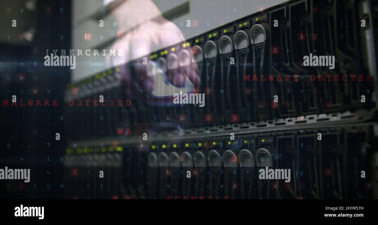 Image of cyber attack warning over hand of caucasian man in server room ...