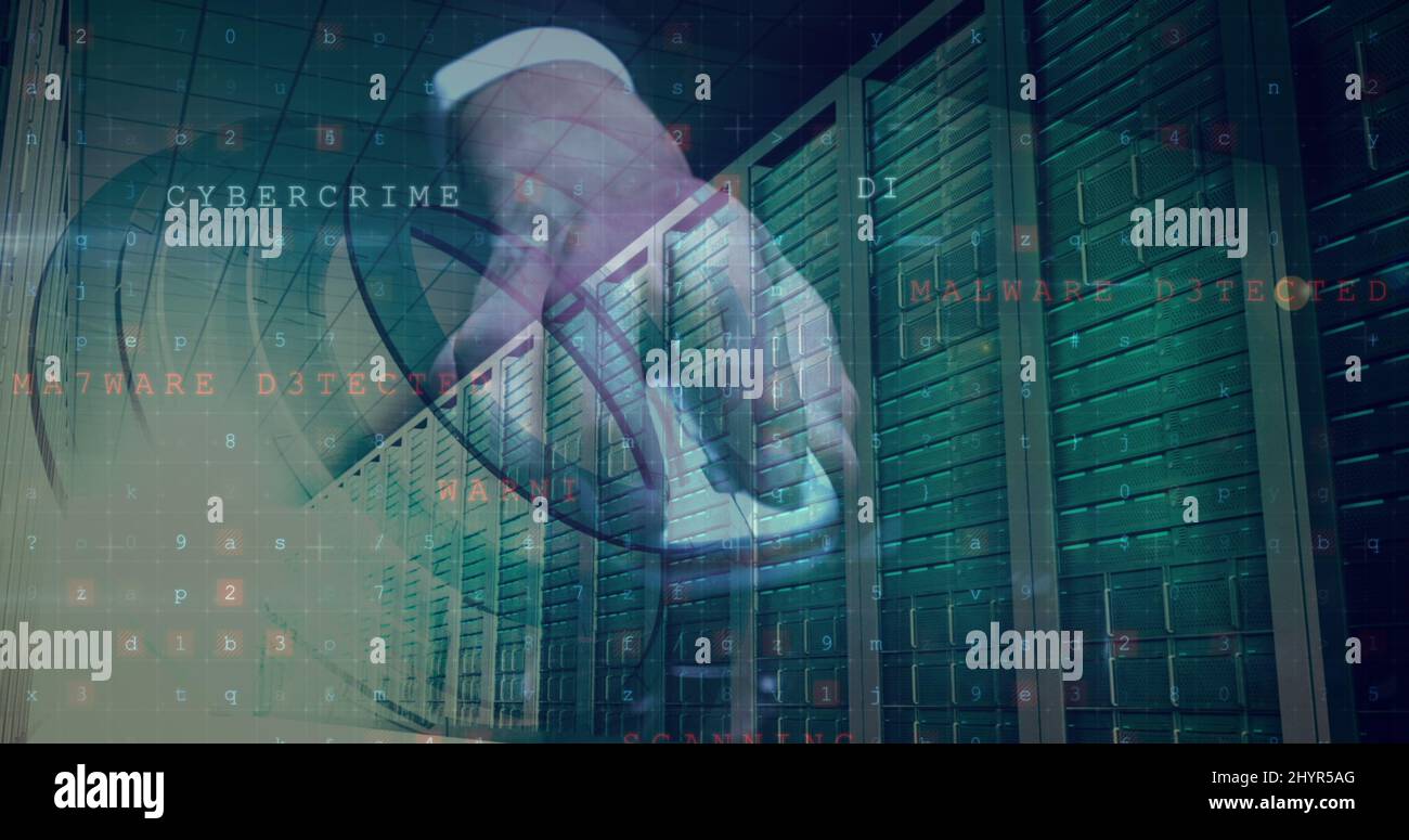 Image of cyber attack warning over hand of caucasian man in server room ...