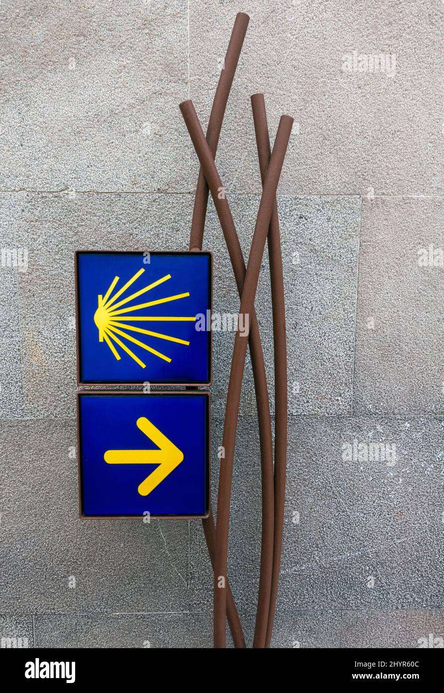 Modern yellow arrows and shell symbol directing pilgrims on the Camino ...