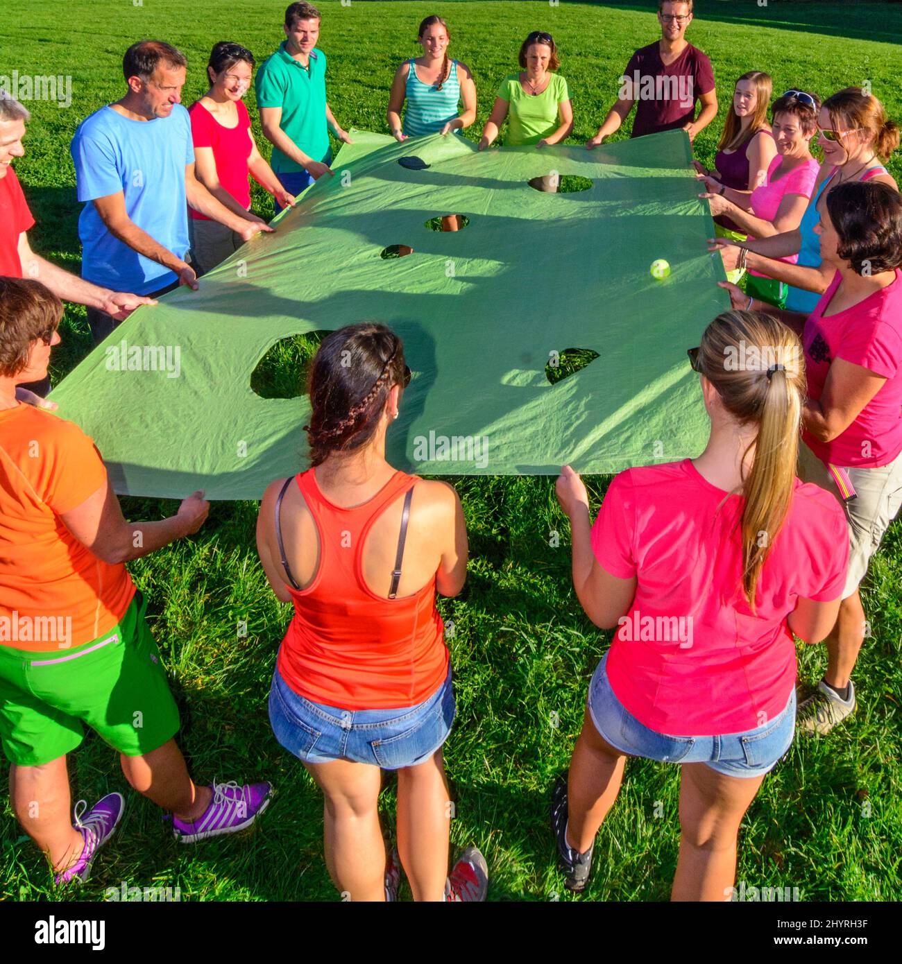 Team exercise - drop a ball into a hole together Stock Photo - Alamy