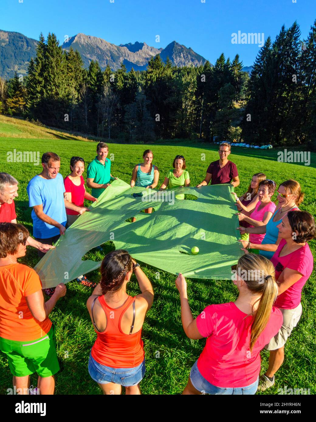 Team exercise - drop a ball into a hole together Stock Photo - Alamy