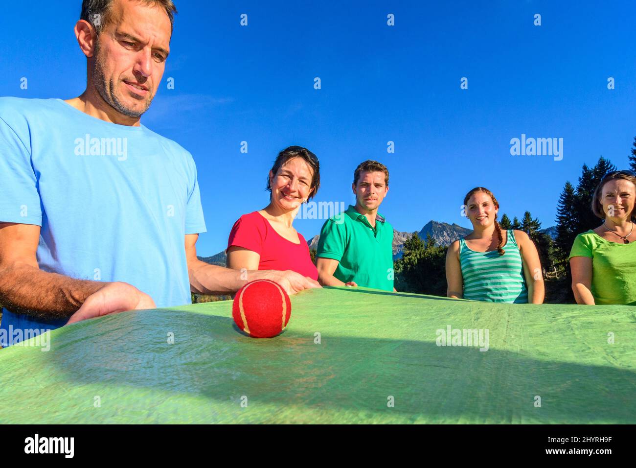 Team exercise - drop a ball into a hole together Stock Photo - Alamy