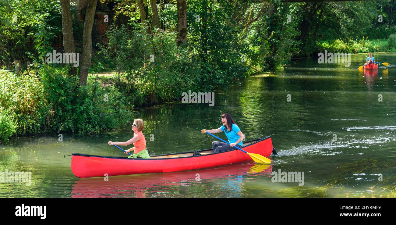 Group of people doing canoe tour on idyllic river in franconia Stock ...