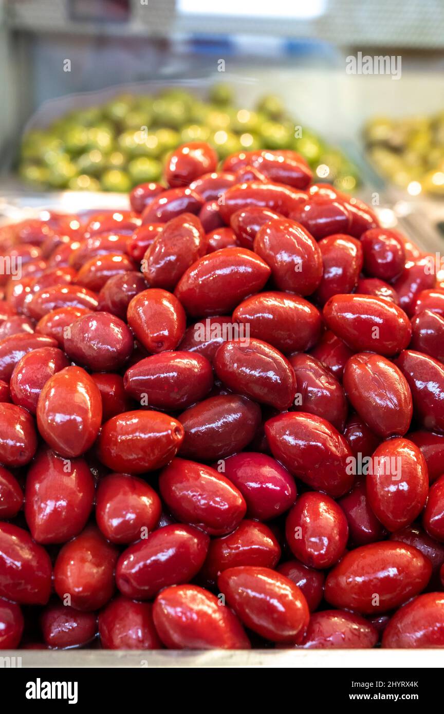 Red olives close up on market, healthy vegetarian food background Stock ...