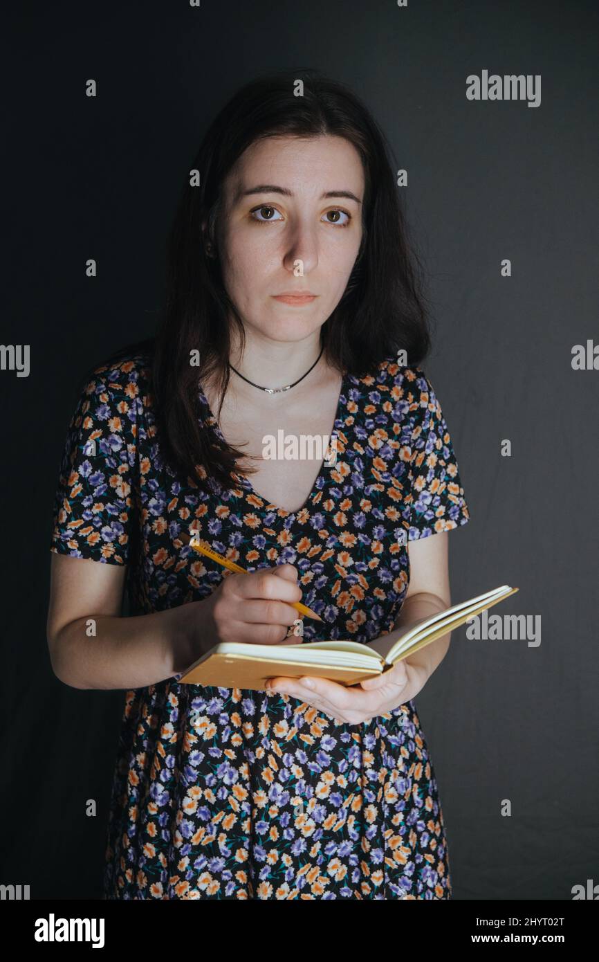 young armenian ukrainian woman take notes with pen in her notebook on a ...