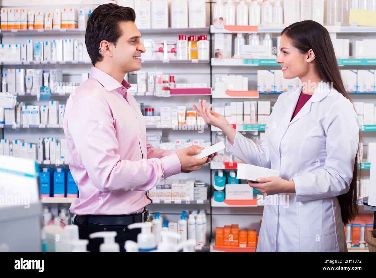 Pharmacist counseling customer about drugs Stock Photo - Alamy