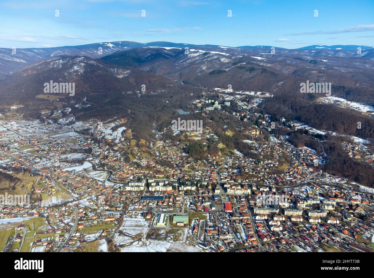 Aerial shot of the city of Sovata surrounded by mountain forests in ...