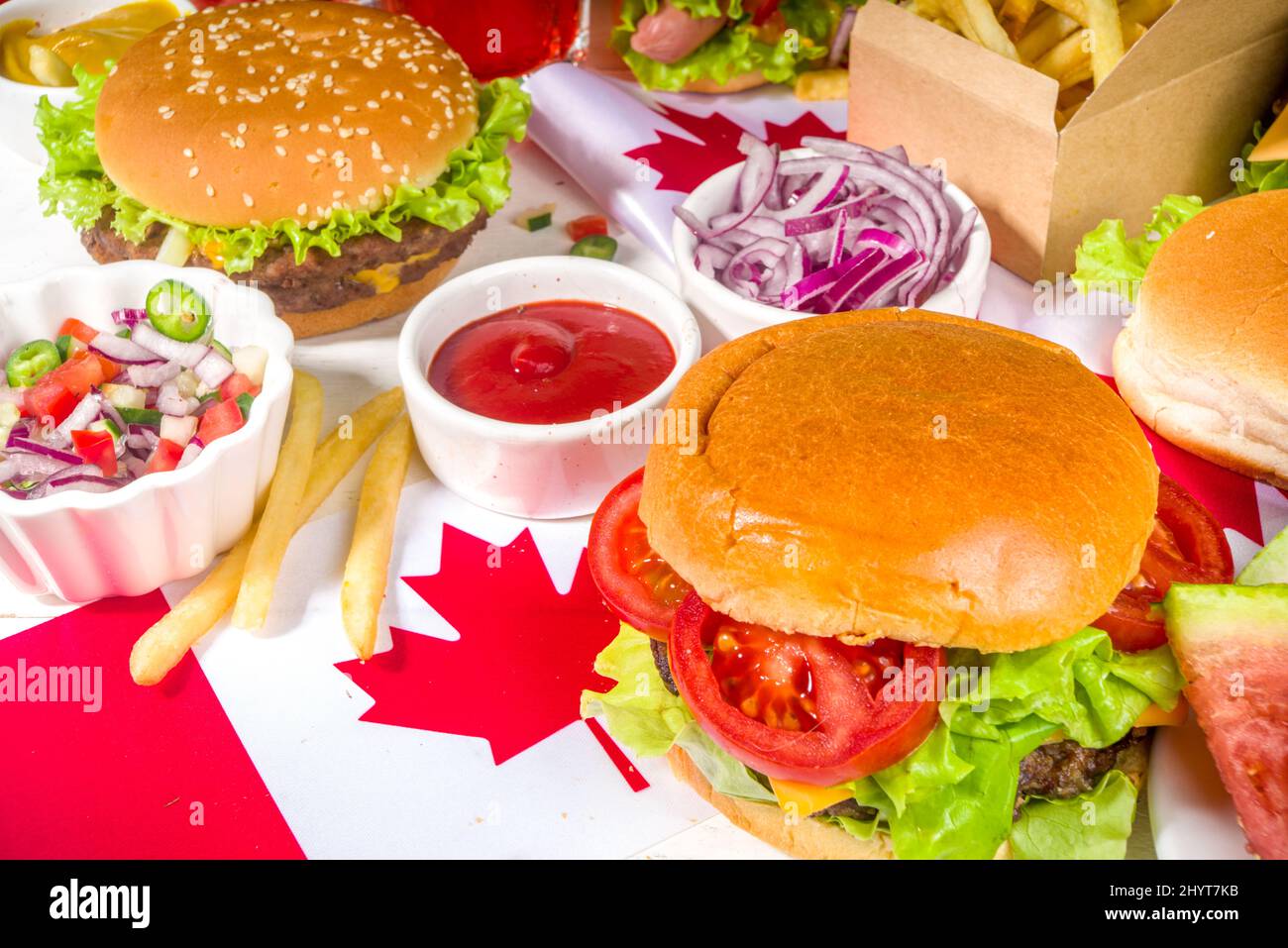 Set of various Canada Day bbq food. Picnic party table with maple leaf ...