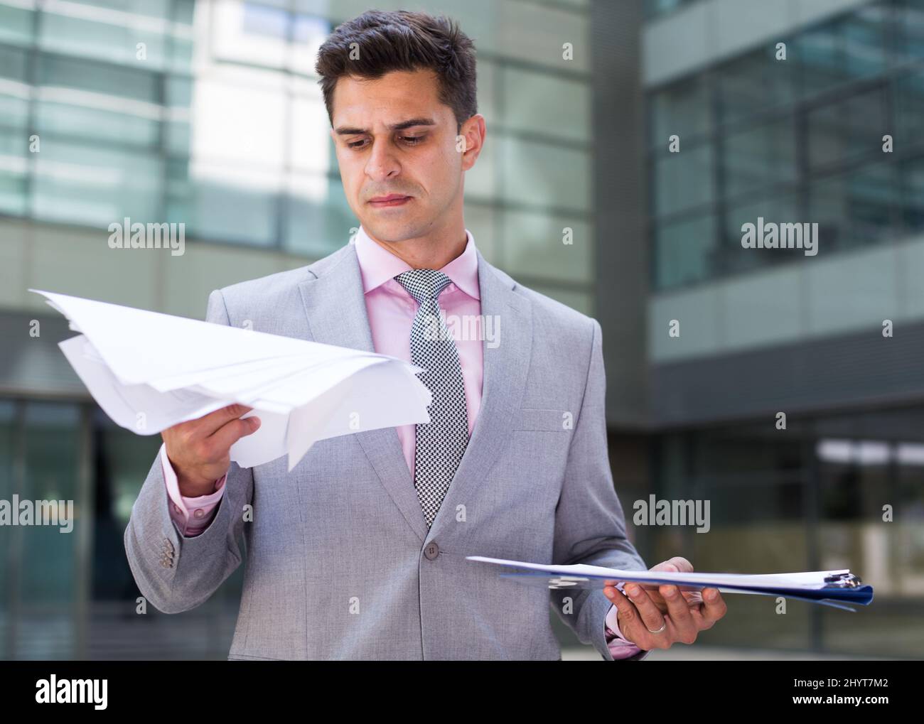 Serious manager reading papers Stock Photo - Alamy