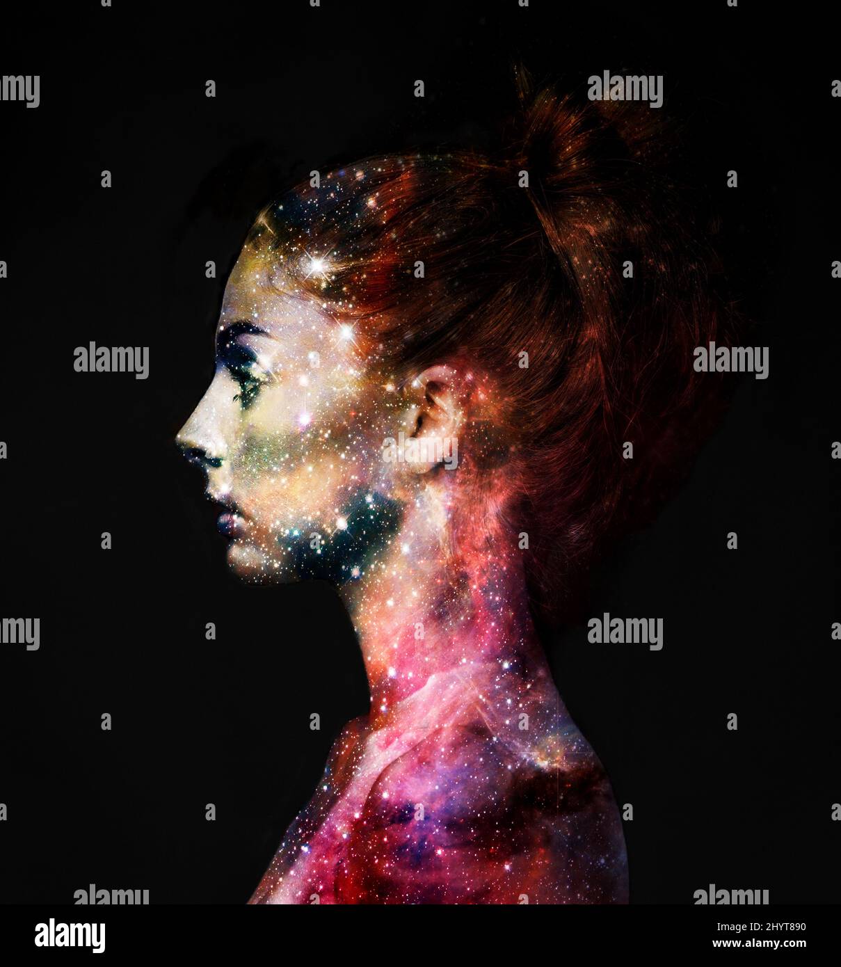 Intergalactic beauty. Profile of a young woman with the galaxy overlaid ...