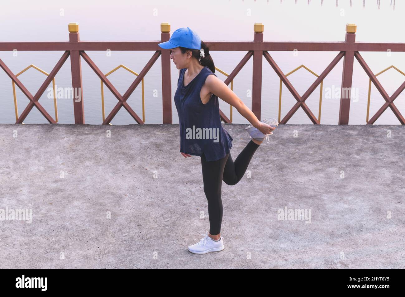 Female fitness doing stretch exercising after workout outside by the ...