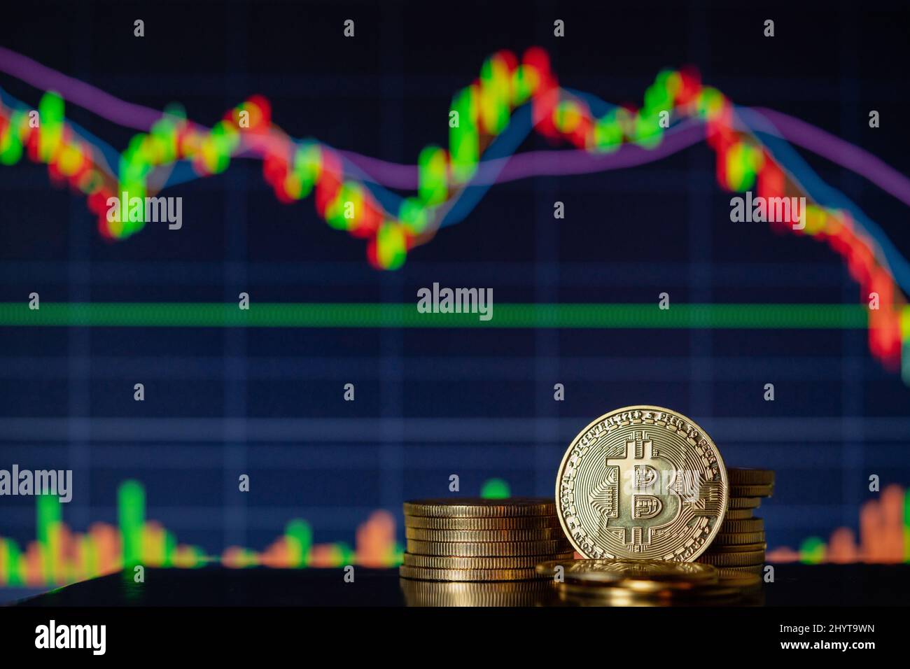 Stack or heap of gold Bitcoins cryptocurrency with candle stick graph ...