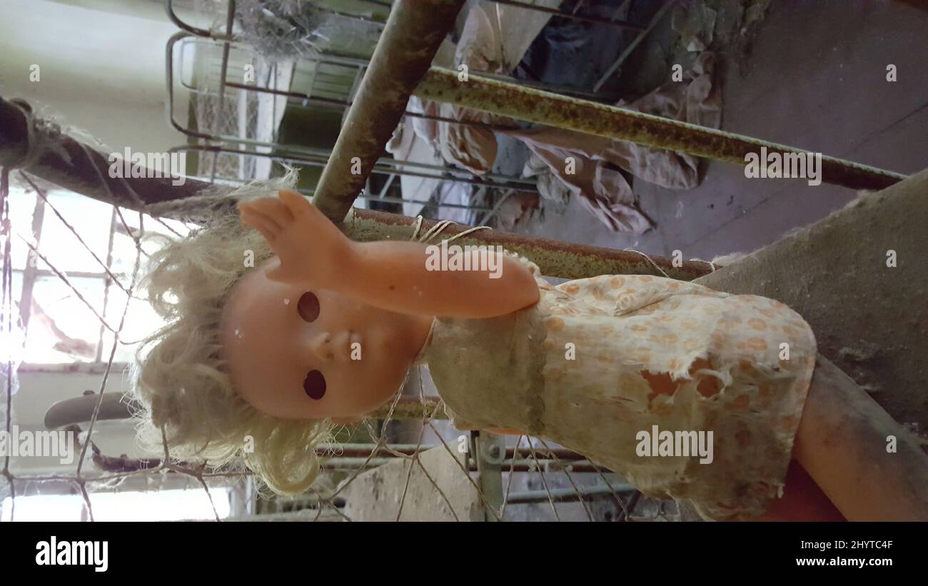Vertical shot of a doll in a kindergarten in Chernobyl waving with a ...