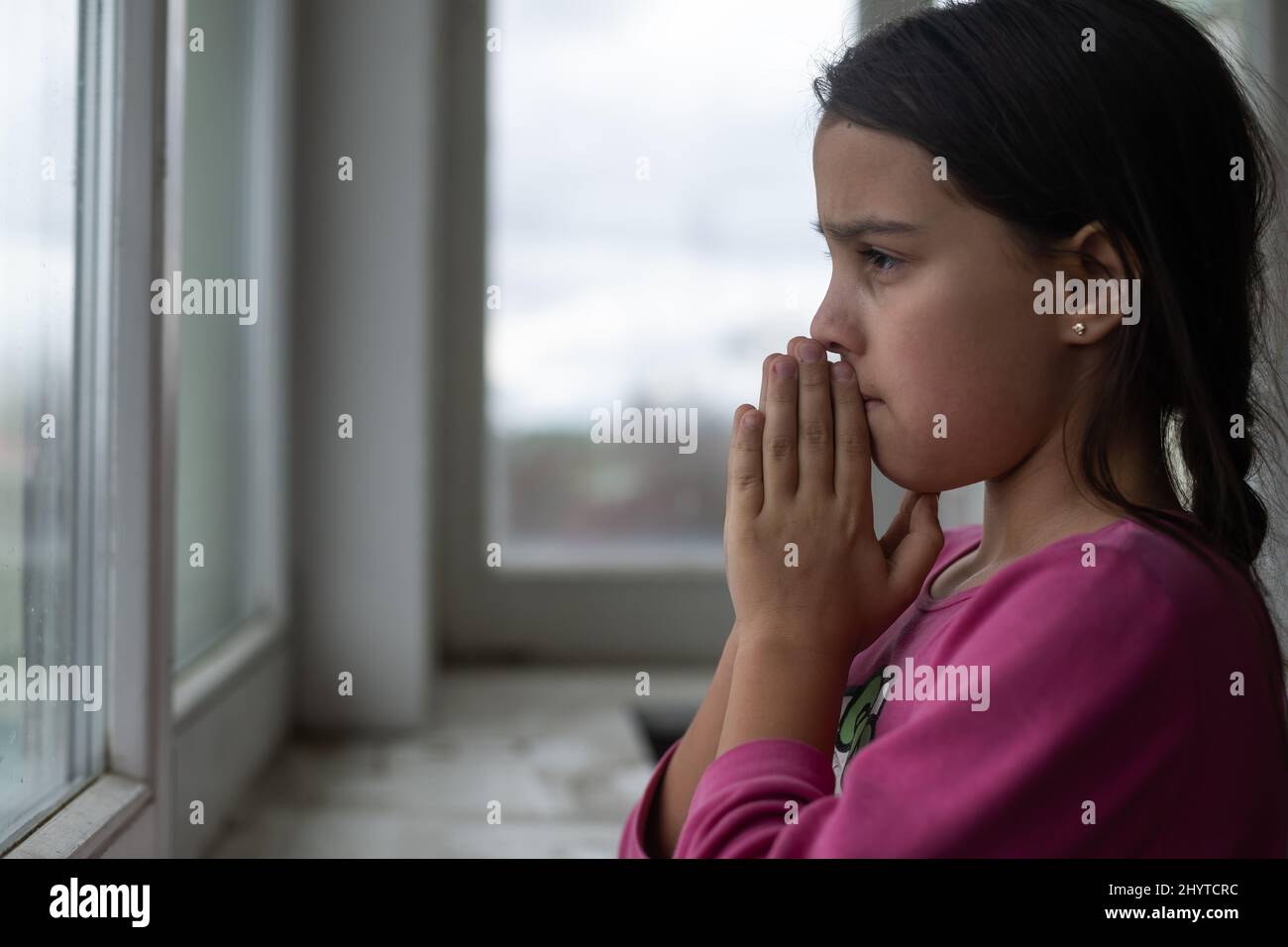 little girl praying near the window Stock Photo - Alamy