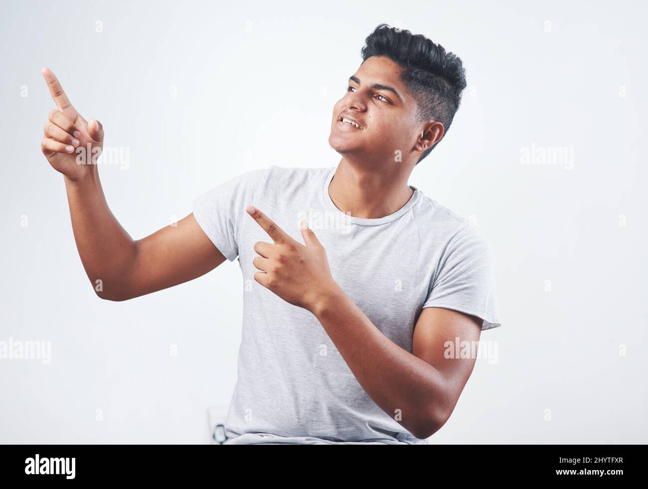 Now thats what Im talking about. Studio shot of a young man pointing at ...