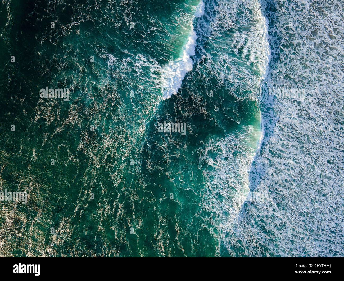 Bird's eye view of teal ocean waves nearing the shore Stock Photo - Alamy