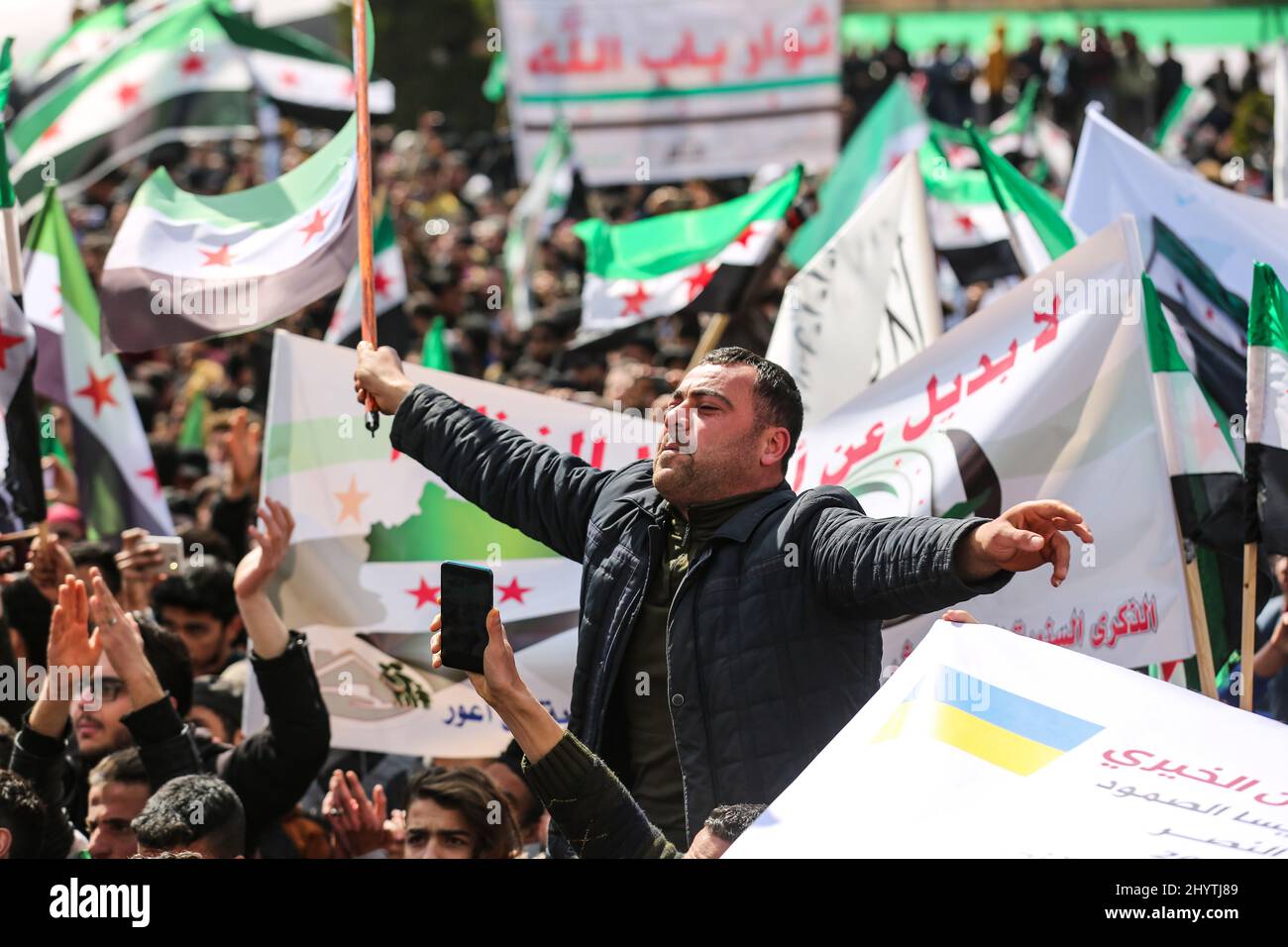 Idlib City, Syria. 15th Mar, 2022. A Syrian demonstrator shouts slogans ...