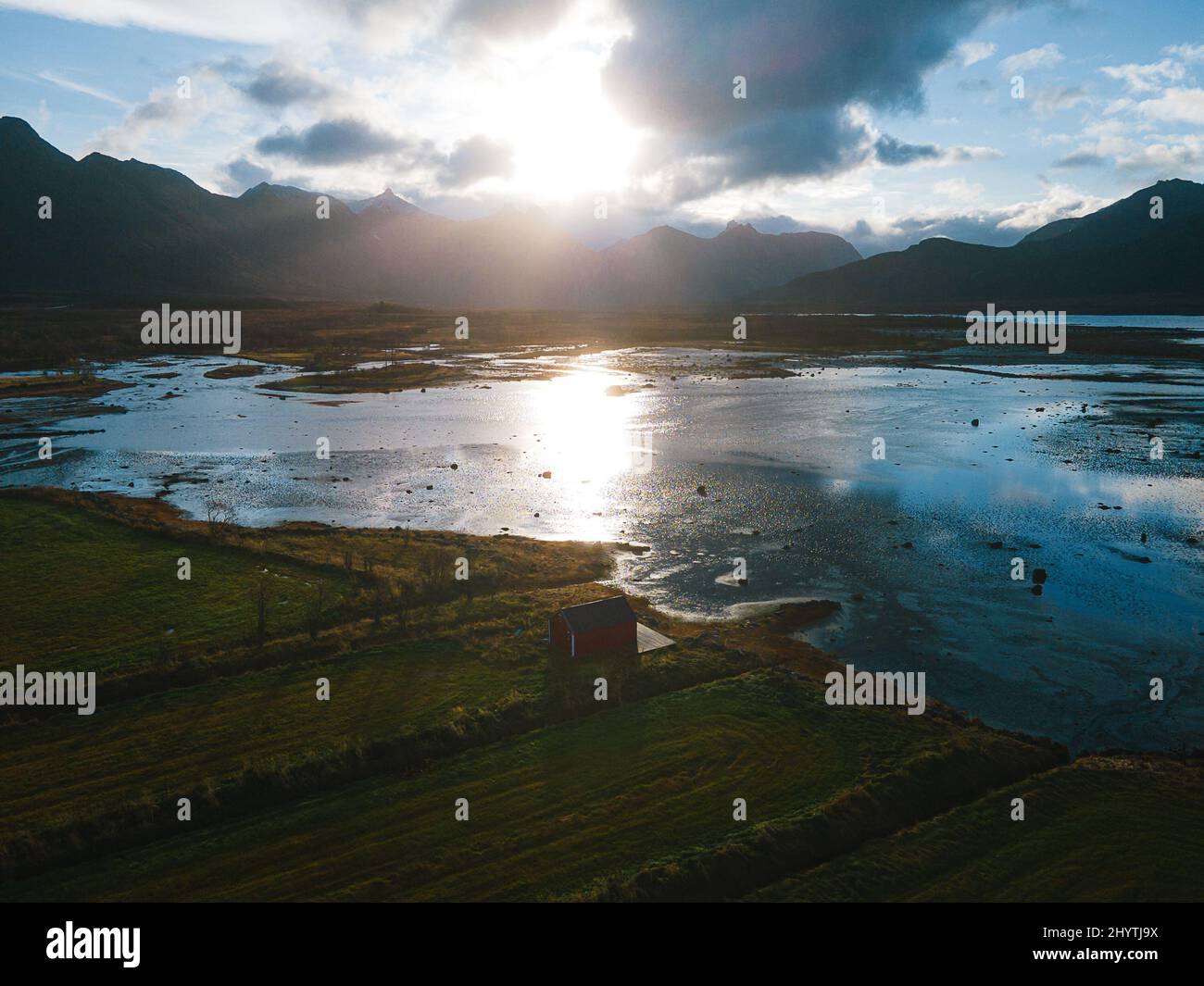 Aerial view of a wetland, mountains and fields under sunbeams Stock ...