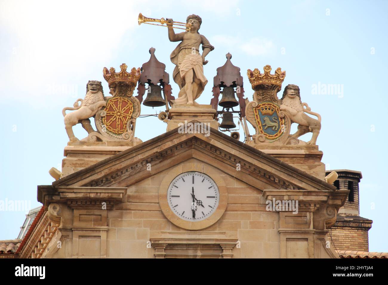 Low angle shot of the clock and sculptures on the facade of Town Hall ...