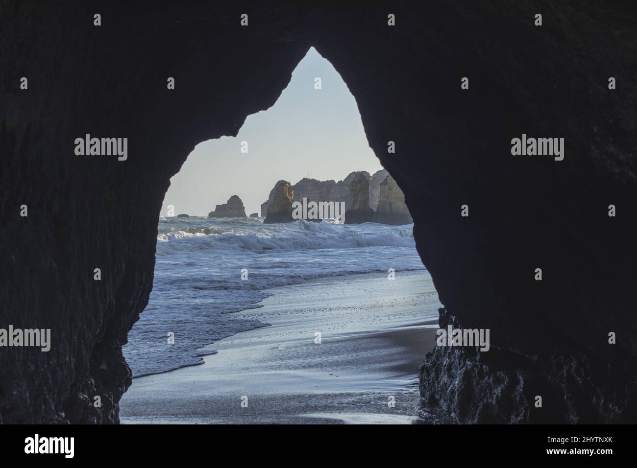 Mesmerizing view of the cliffs over the splashing sea water from the ...