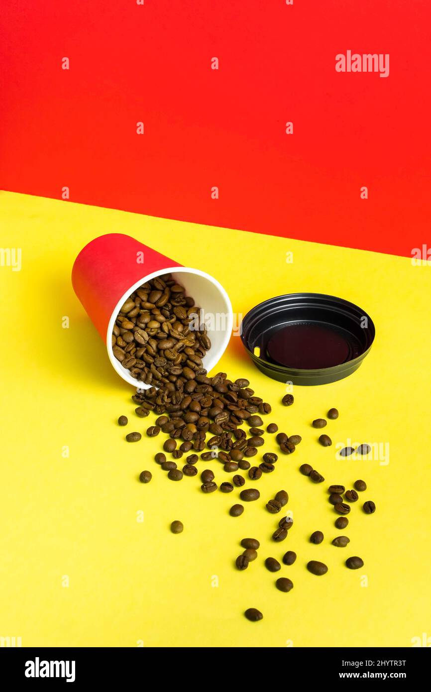 Takeaway red paper coffee cup with black cap on red and yellow ...