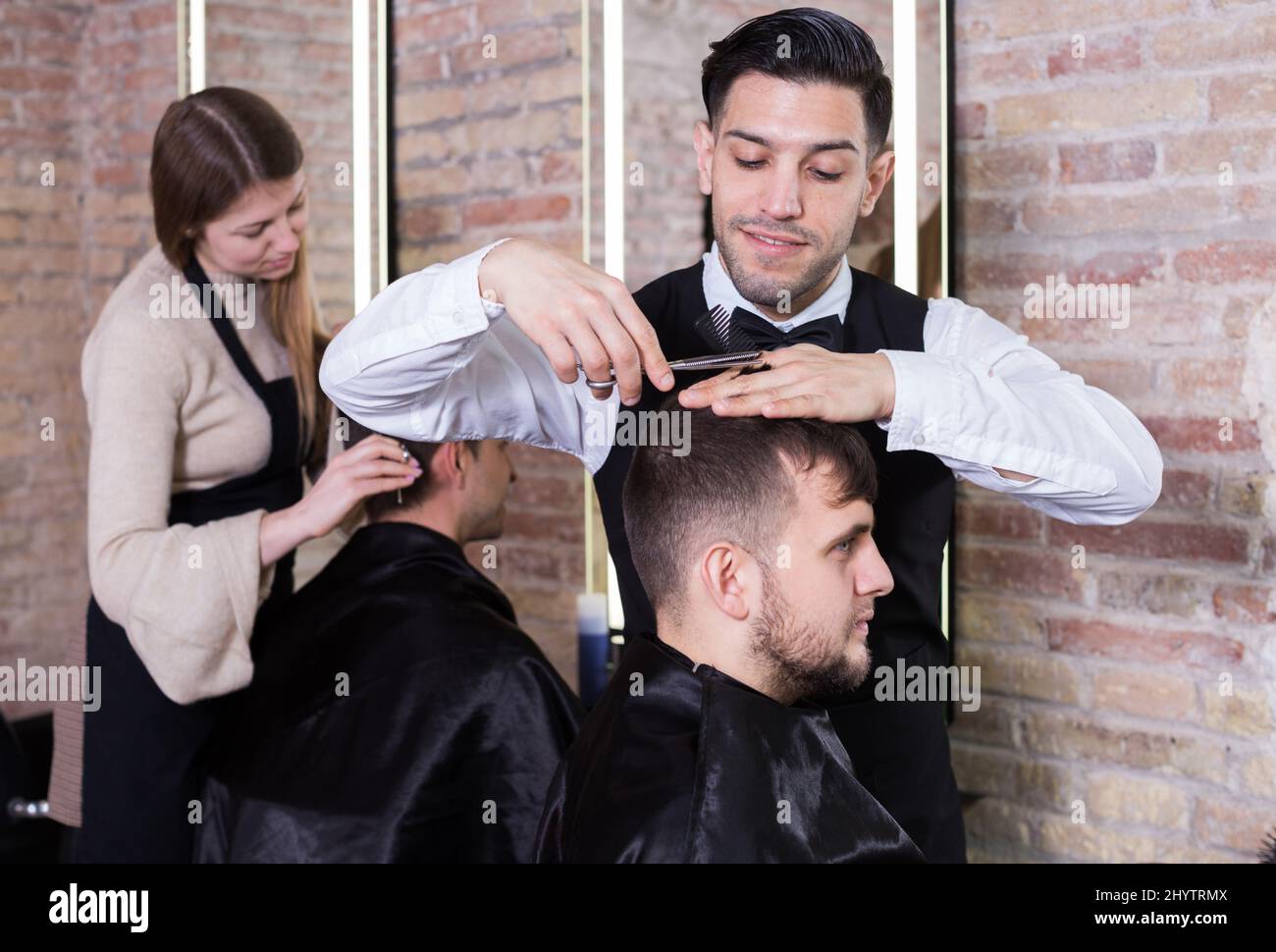 Professional hairdresser doing hair cutting hi-res stock photography ...