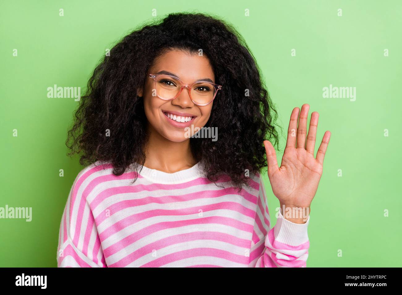 Portrait of attractive cheerful friendly girl nerd waving hi hello ...