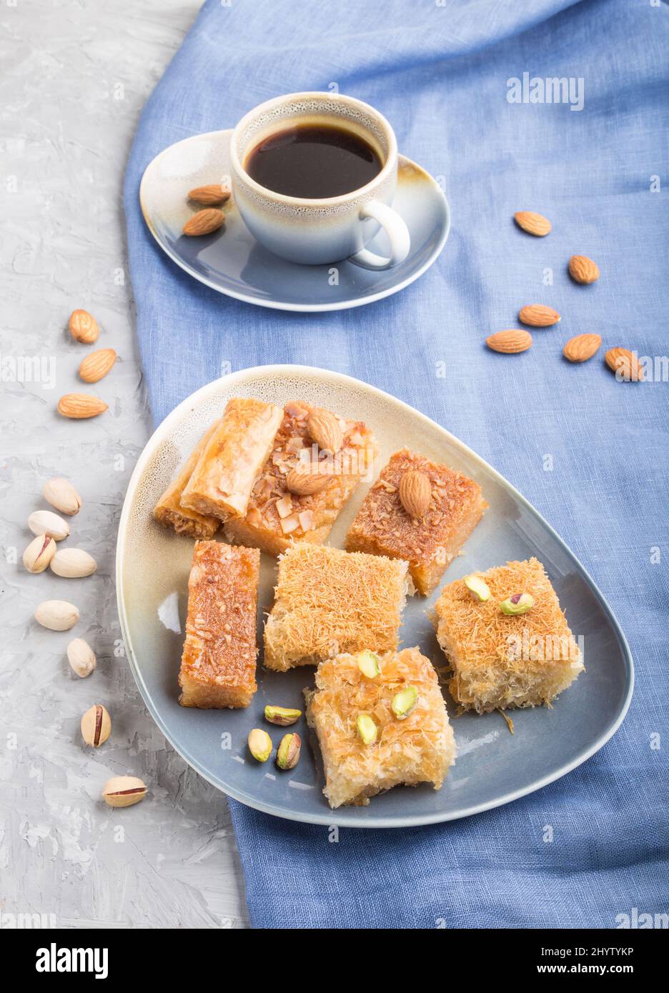 traditional arabic sweets (basbus, kunafa, baklava) and a cup of coffee ...