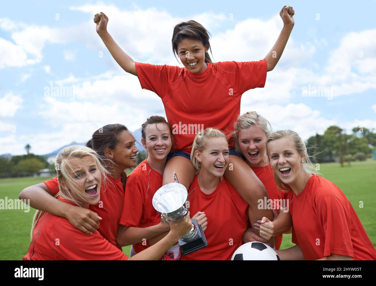 We are the champions. Portrait of an all-girls soccer team raising ...