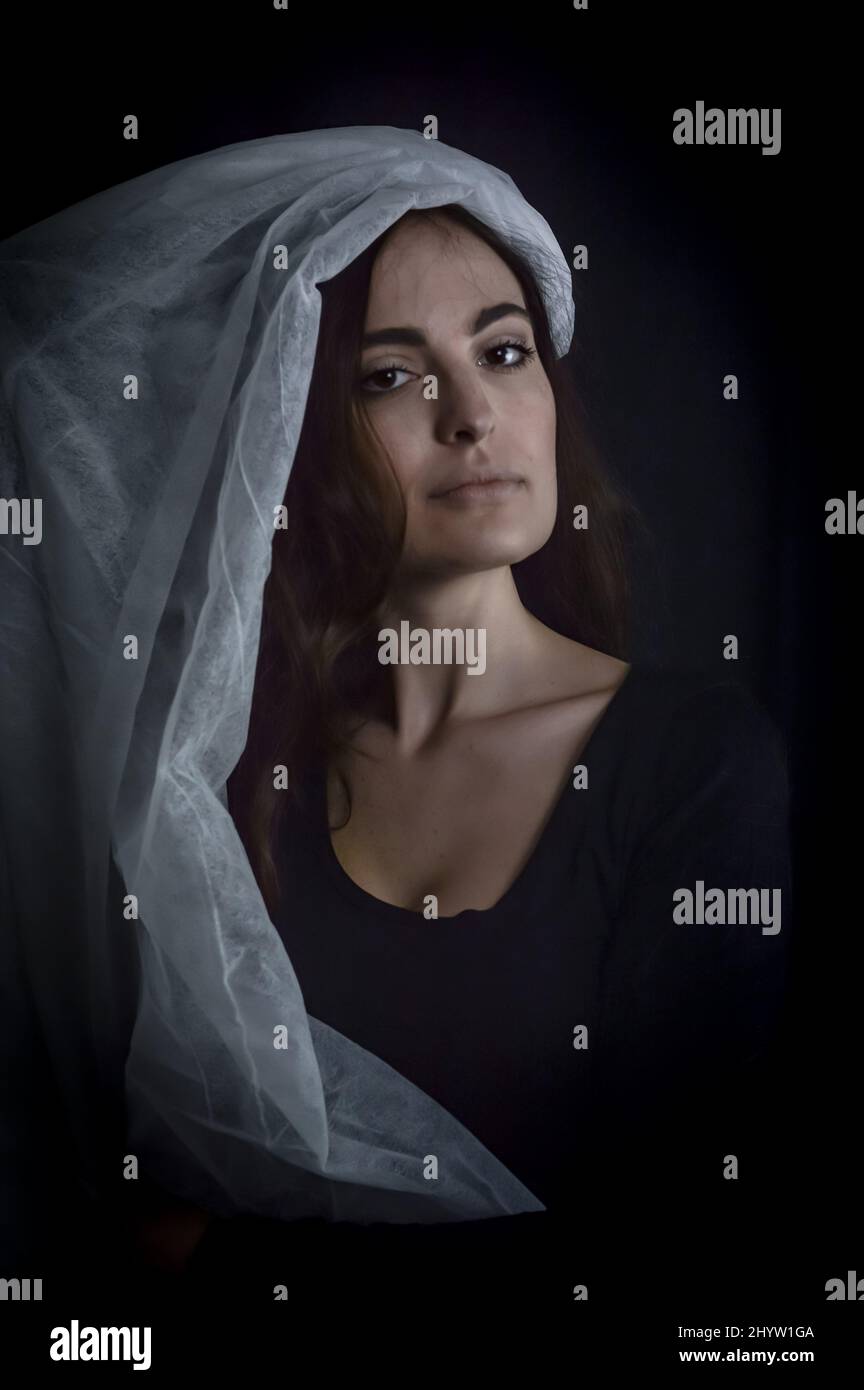 Portrait Of A Beautiful Woman With A White Textile On Her Head With A