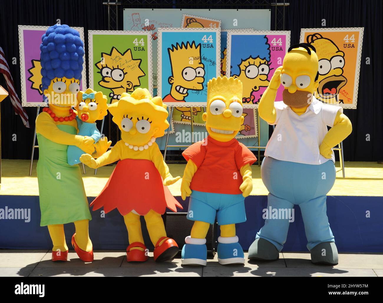 Characters dressed as The Simpsons, from left, Marge, holding Maggie ...