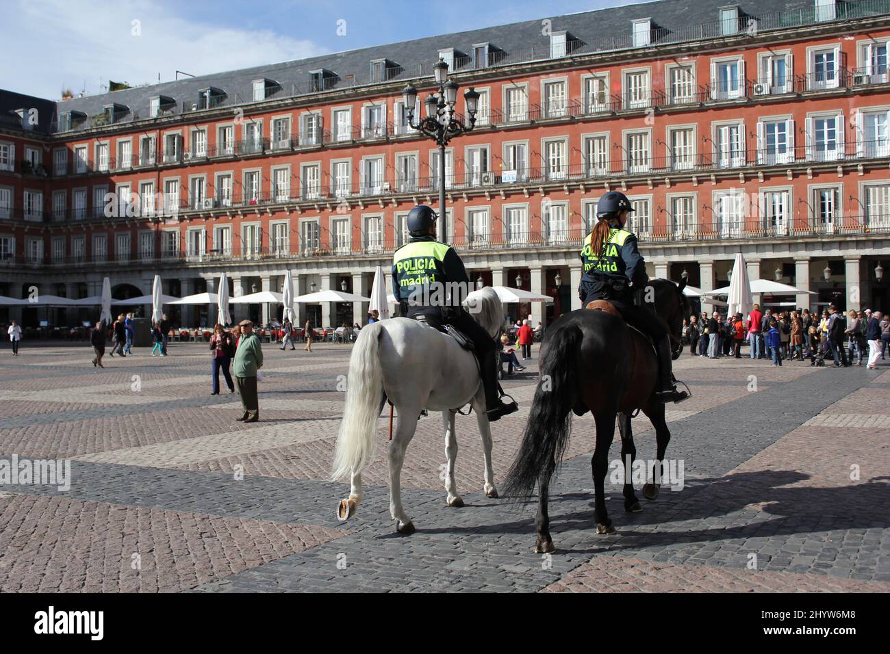 Photo of police officers riding horses in a city Stock Photo - Alamy