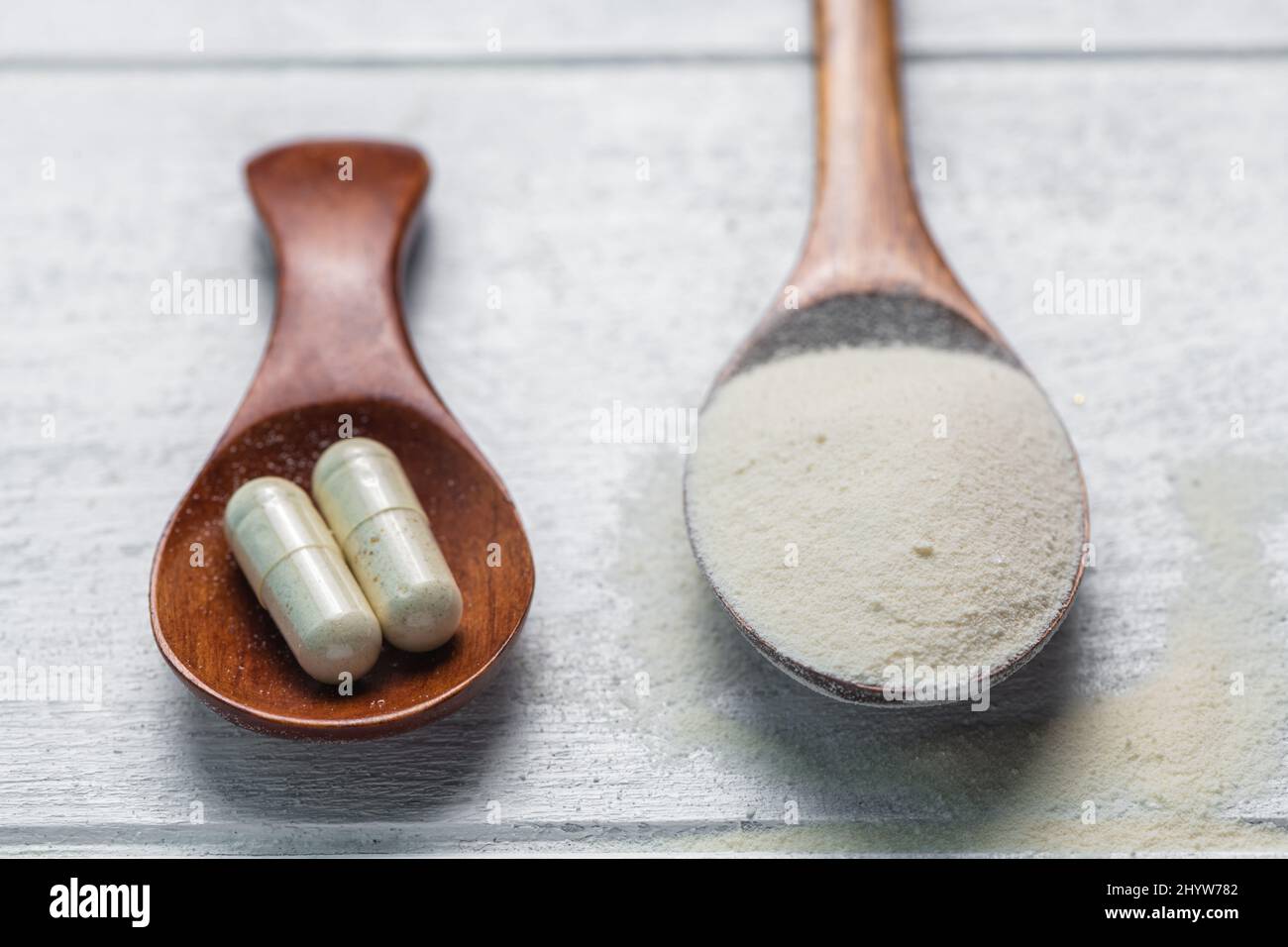 collagen in tablets and powder on wooden white background Stock Photo ...