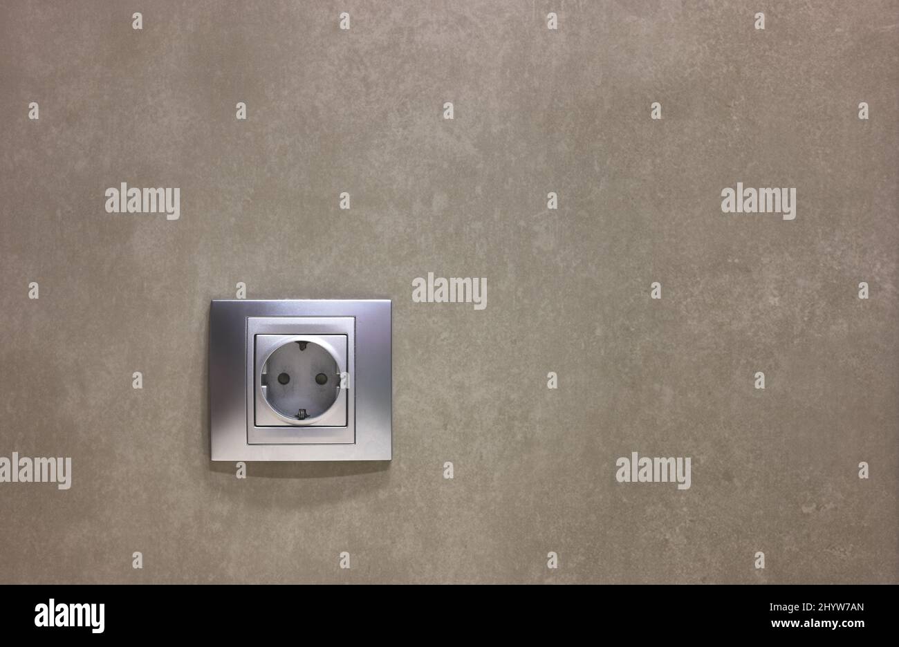 detail of a metallised electrical socket in a ceramic tiled wall Stock ...