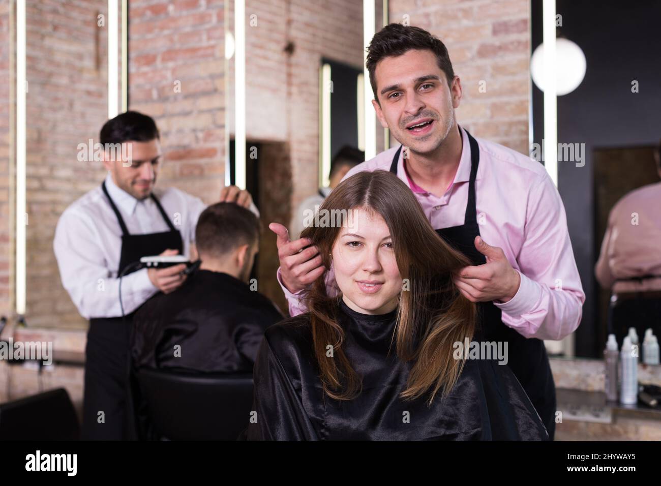 Female discussing haircut with hairdresser Stock Photo - Alamy