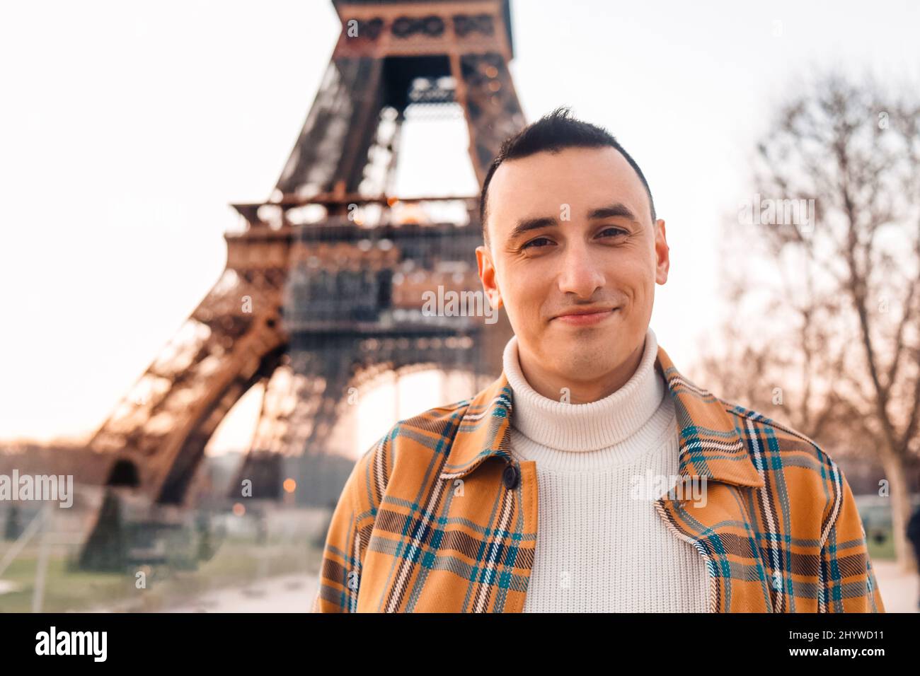 Guy tourist on the background of the Eiffel Tower posing. Male tourist ...