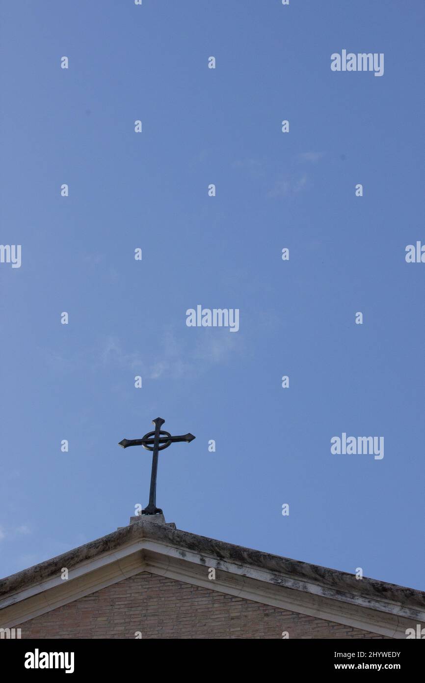 Low angle of a cross on the top of a church against the blue sky Stock ...
