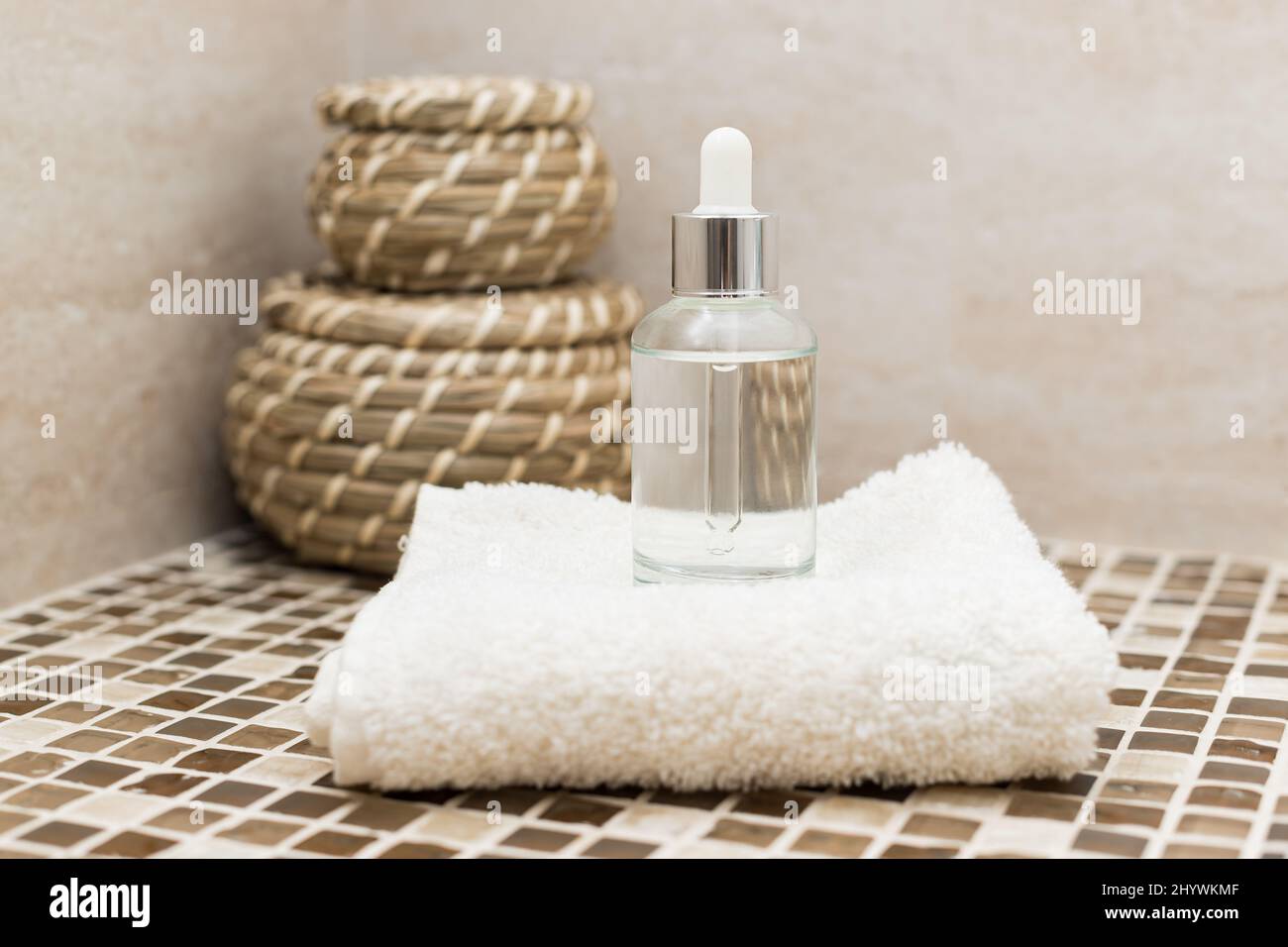 Cosmetic glass bottle with dropper on bathroom counter Stock Photo - Alamy