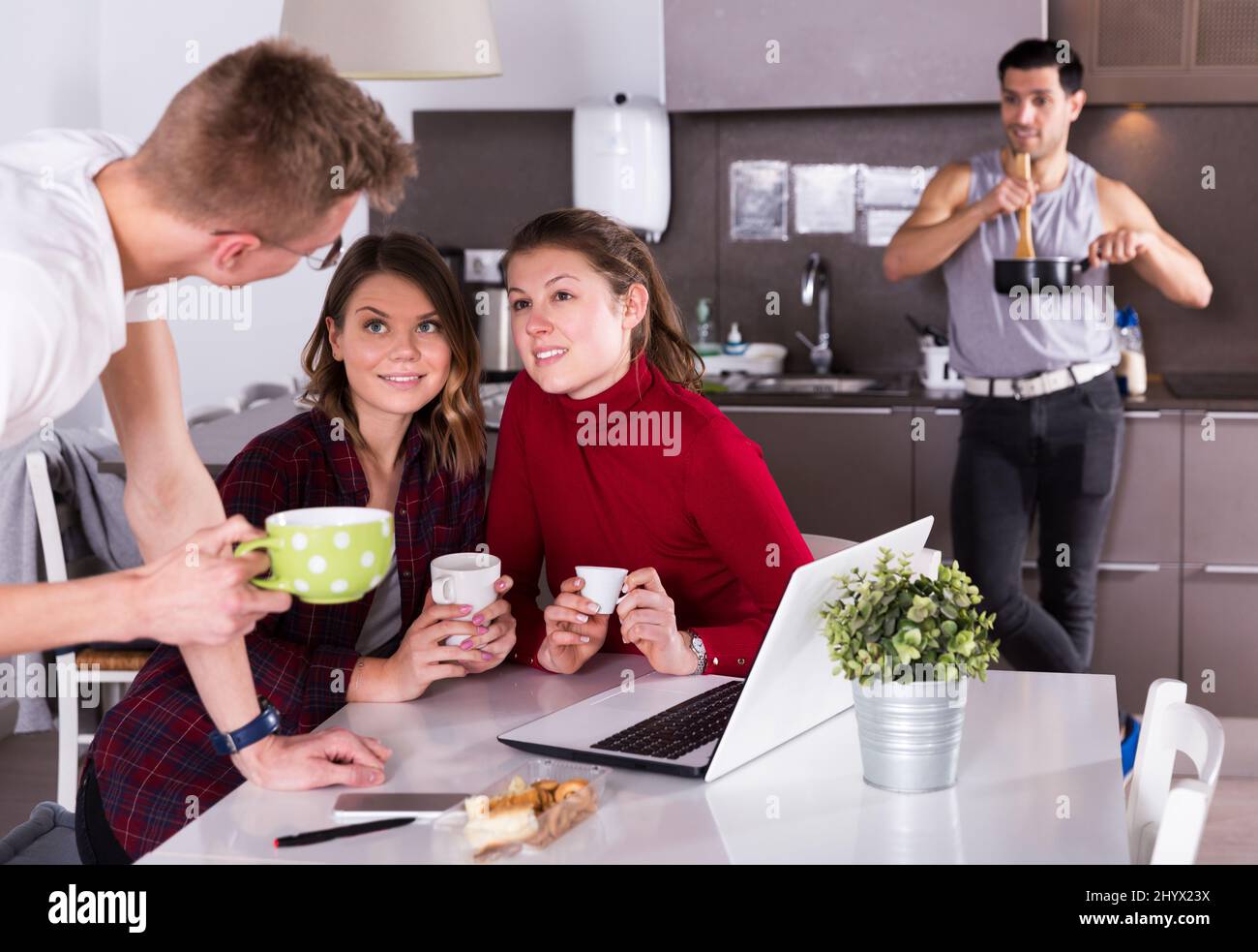 People discussing in hostel kitchen Stock Photo - Alamy