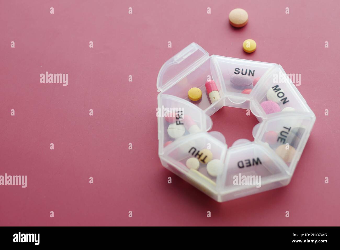 top view of medical pills in a pill box on color background Stock Photo ...