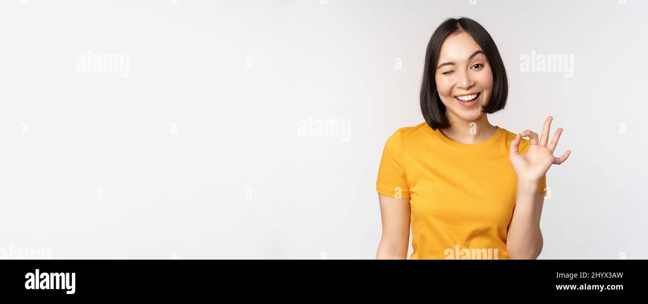 Beautiful young woman showing okay sign, smiling pleased, recommending ...