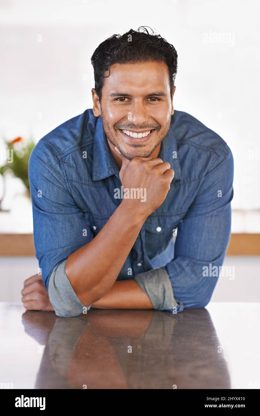 Happiest when hes home. Portrait of a handsome young man leaning on the ...