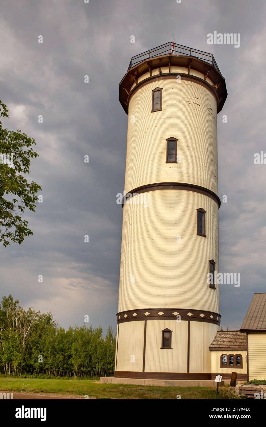 A painted and preserved old water tower with staggered windows serving ...